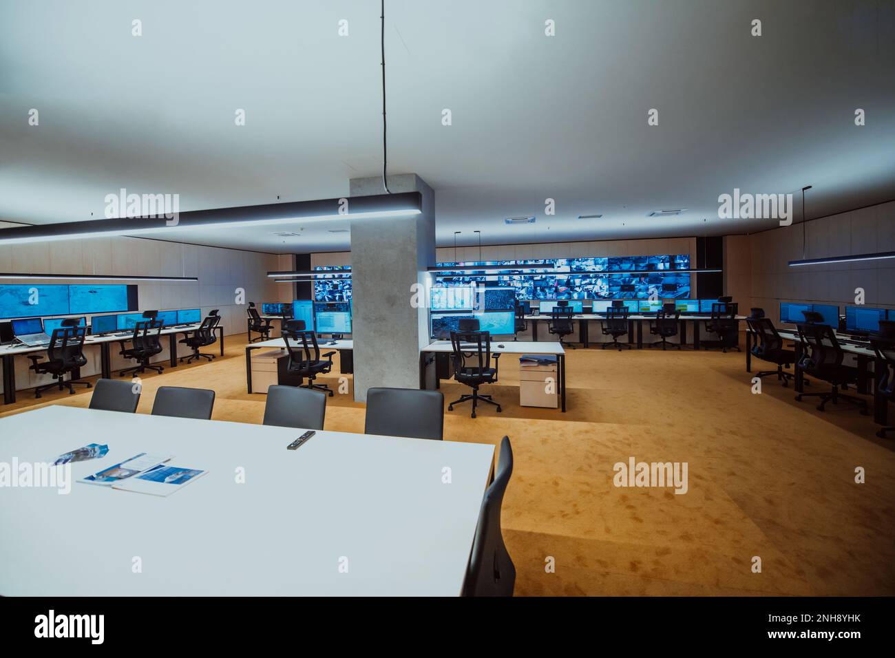 Empty interior of big modern security system control room, workstation ...