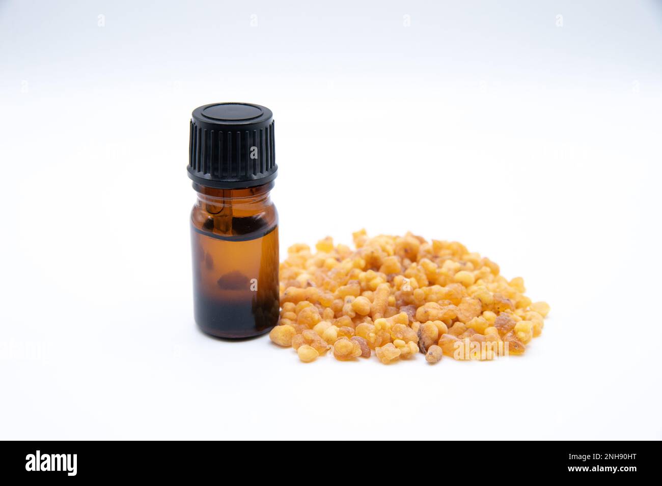A bottle of frankincense essential oil with frankincense resin, close ...