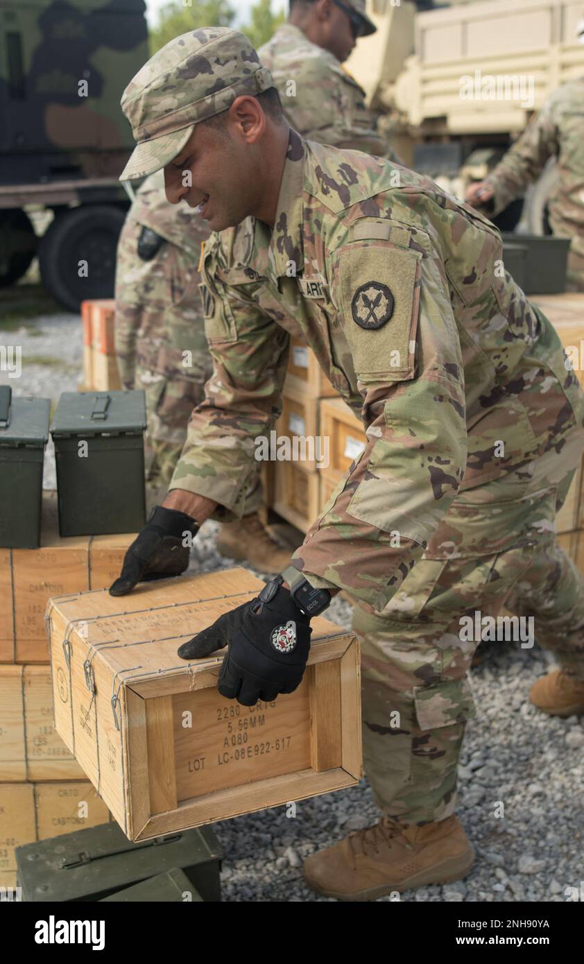Sgt. Luis Gil, a wheel vehicle mechanic, loads crates of ammunition ...