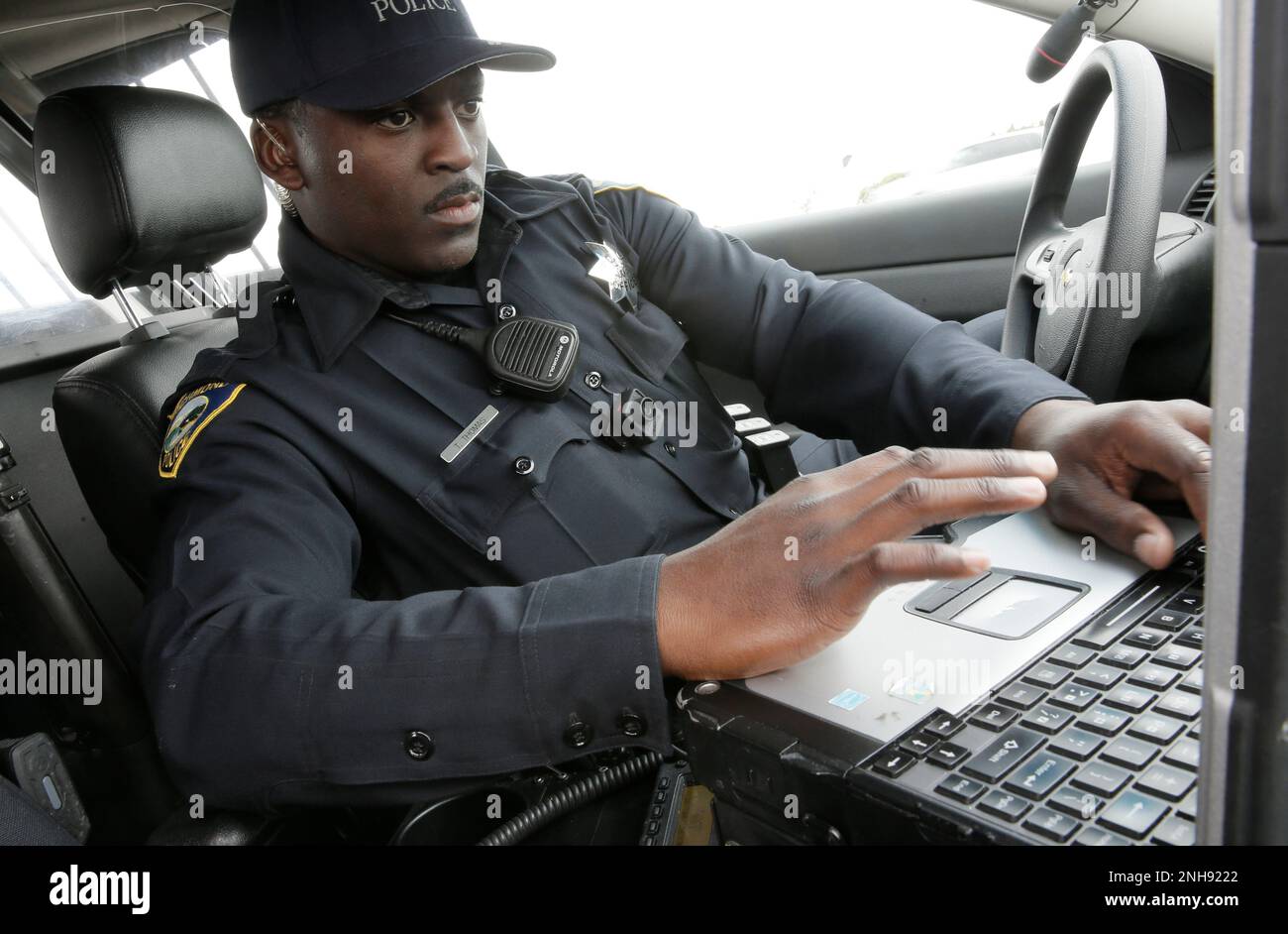 Richmond Police Officer Terry Thomas checks his onboard computer, is ...
