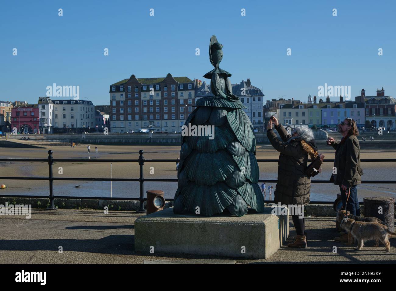 Tourists photographing Mrs Booth - Bronze sculpture mae to look like ...