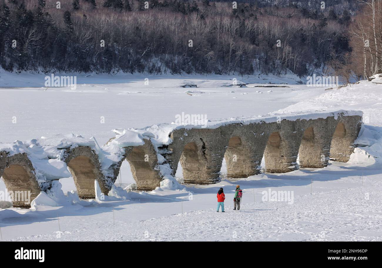 The "Taushubetsu River Bridge" appears over frozen Lake Nukabira in ...