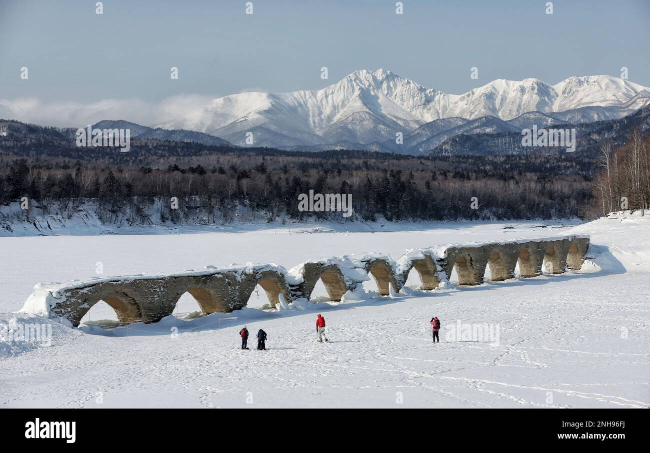 The "Taushubetsu River Bridge" appears over frozen Lake Nukabira in ...