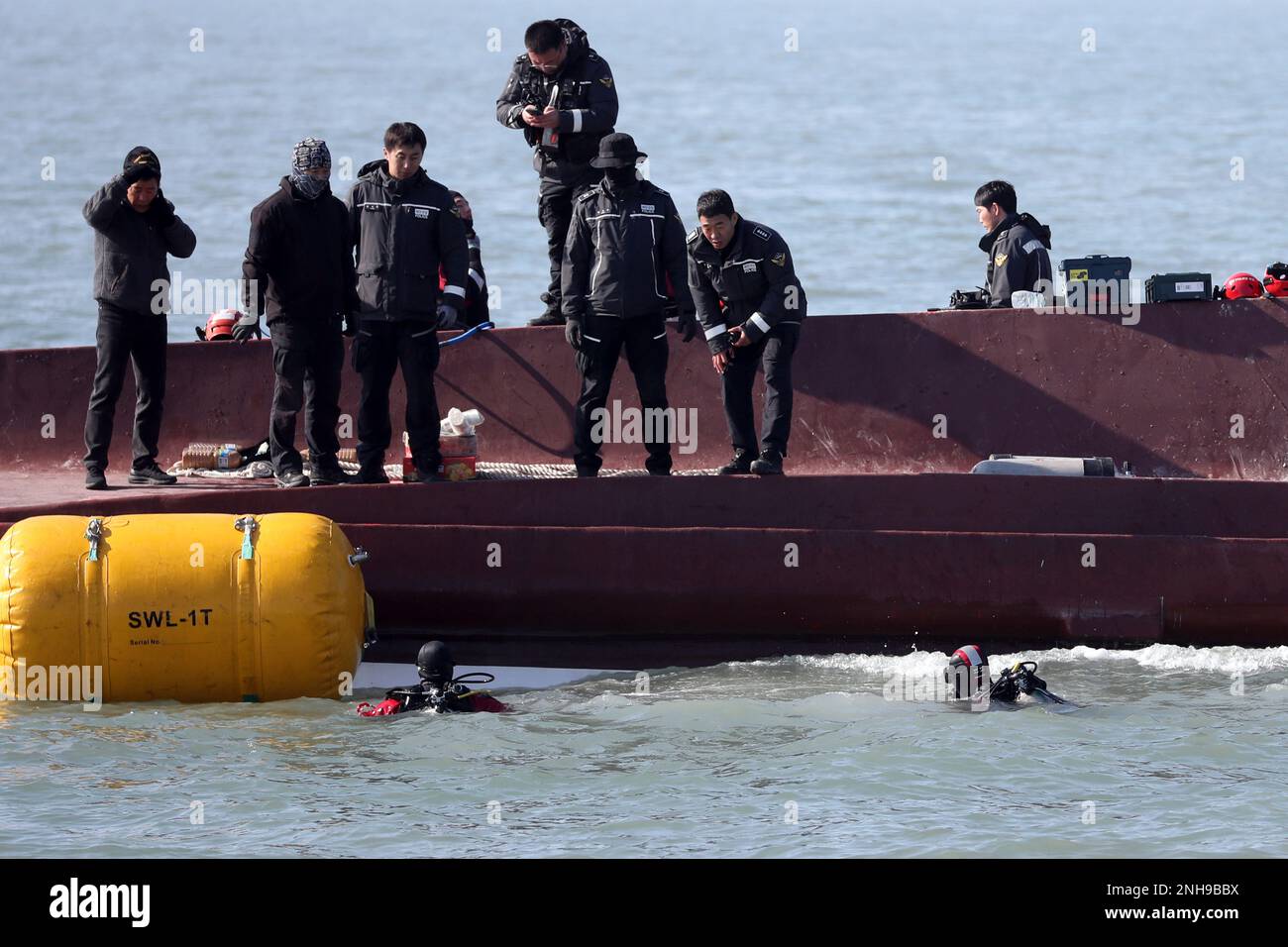 Members of a rescue team search for people from a capsized boat in ...
