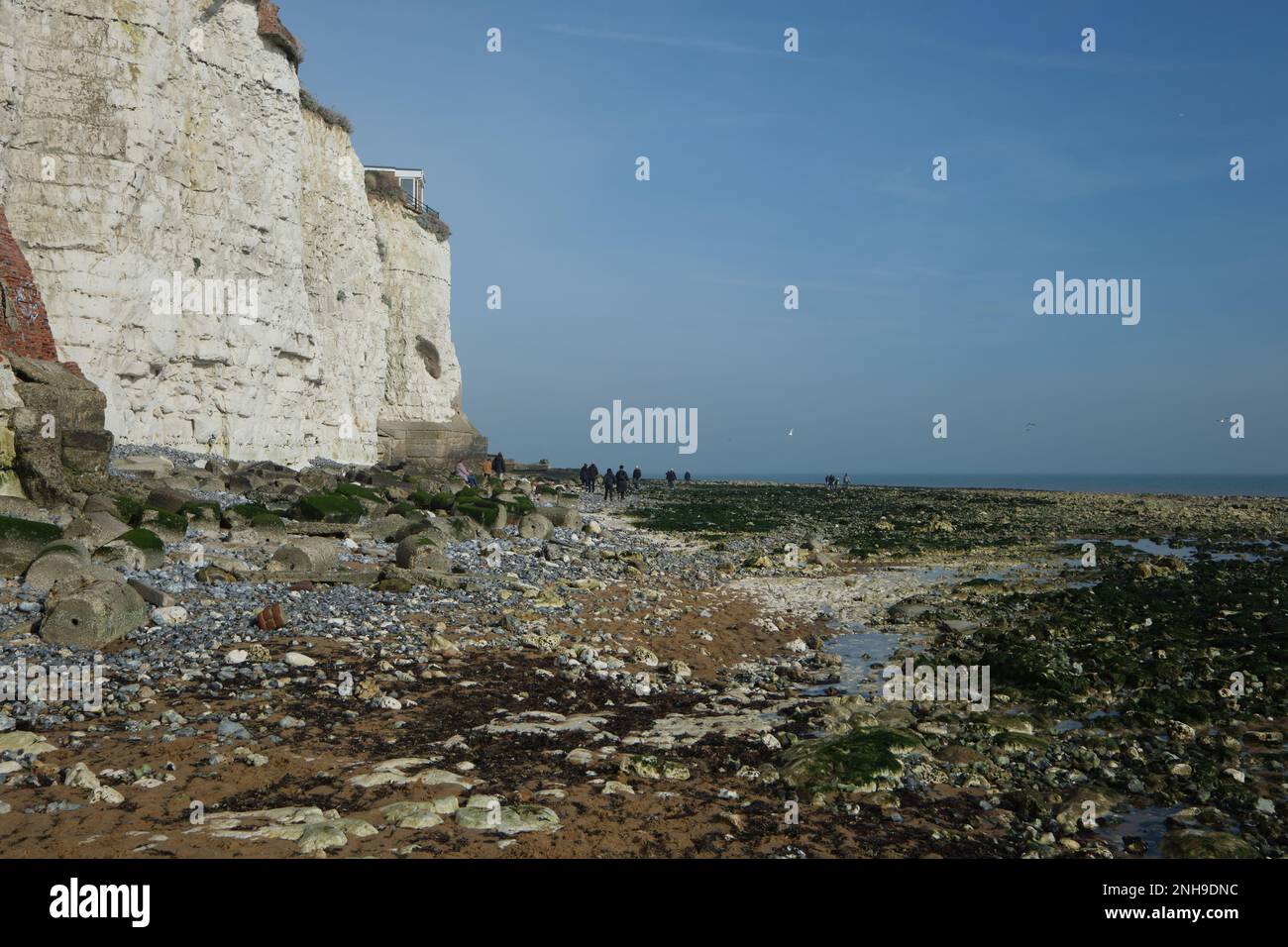 visitors walk along the chalk beach at Stone bay, Broadstairs, kent in ...