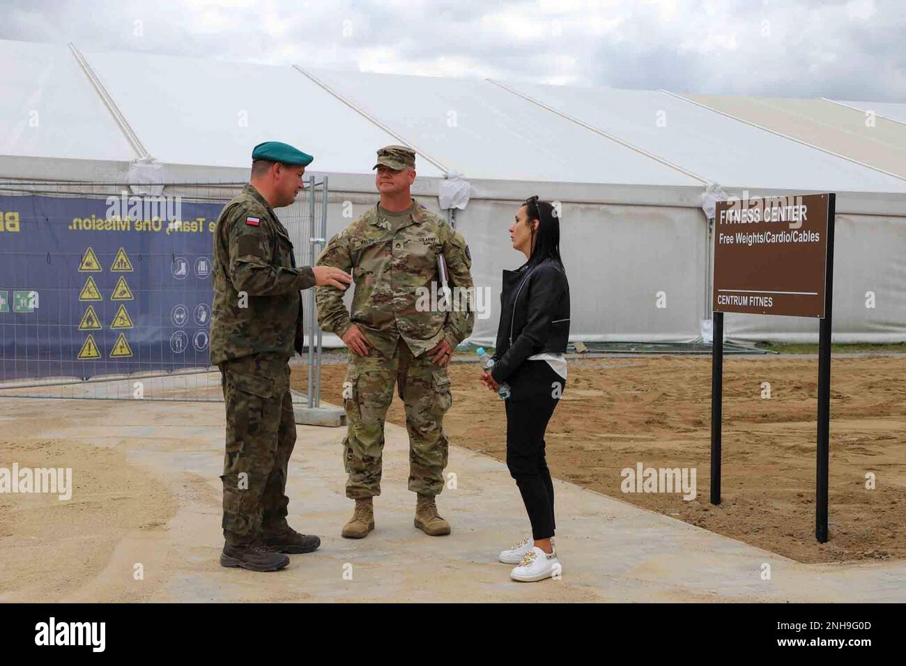 Staff Sgt. John Walsh speaks with the Polish Base Commander and the ...