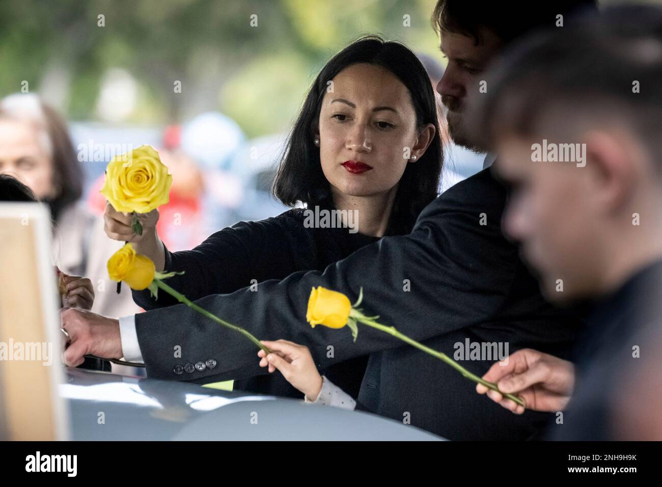 Kristenne Reidy, the daughter of Valentino Alvero, places a flower on ...