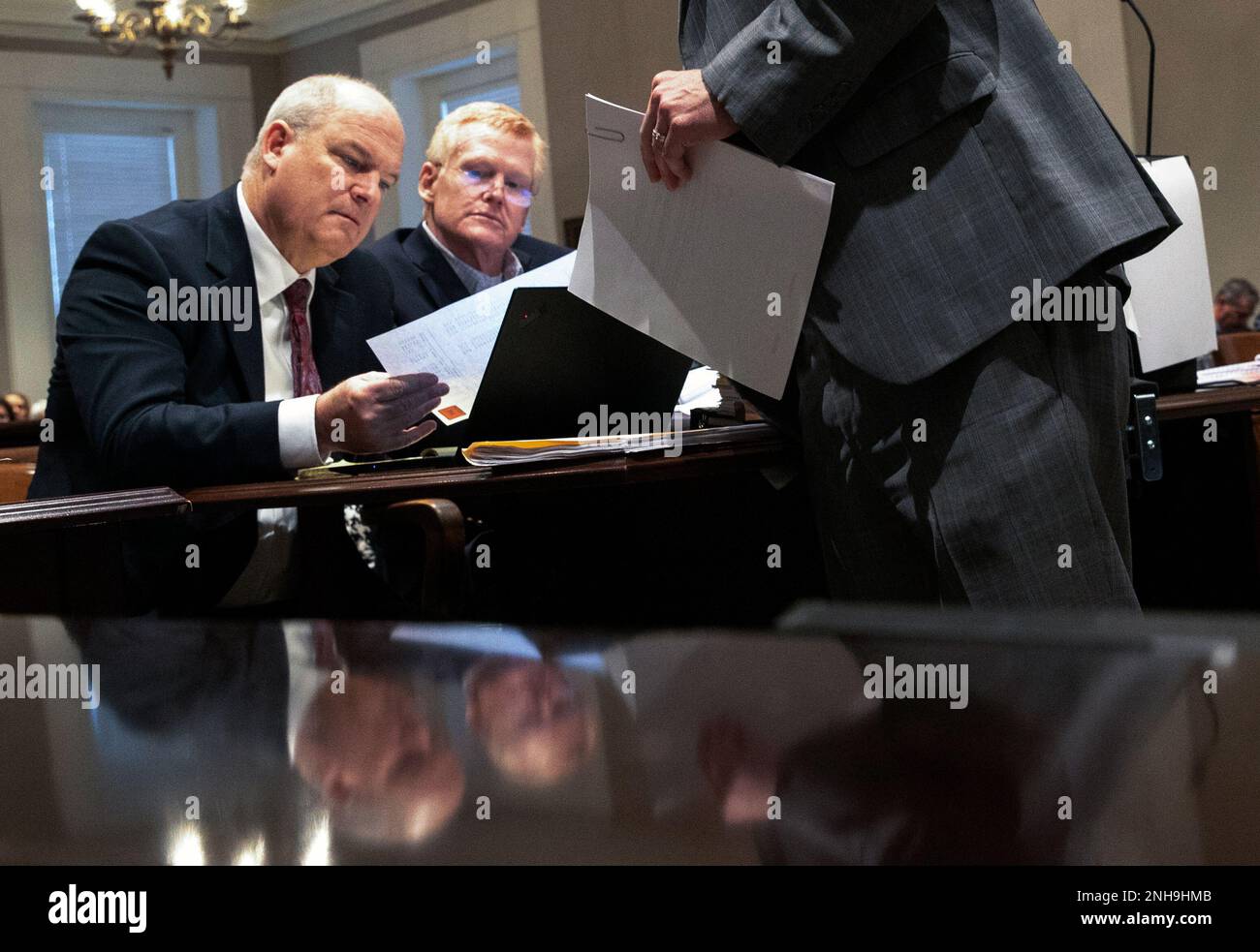 Defense attorney Jim Griffin, left, looks over evidence alongside Alex ...