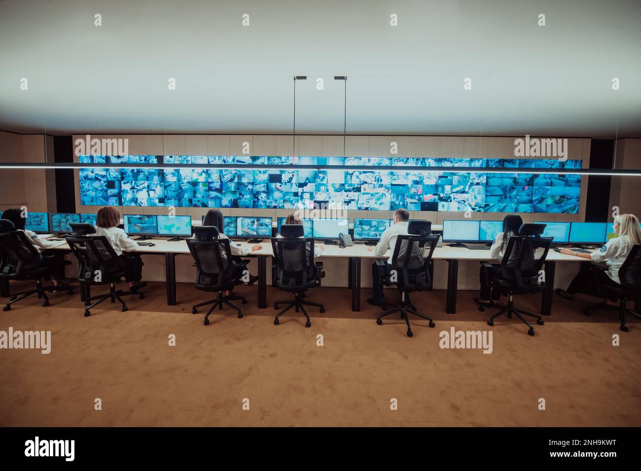Group of Security data center operators working in a CCTV monitoring ...