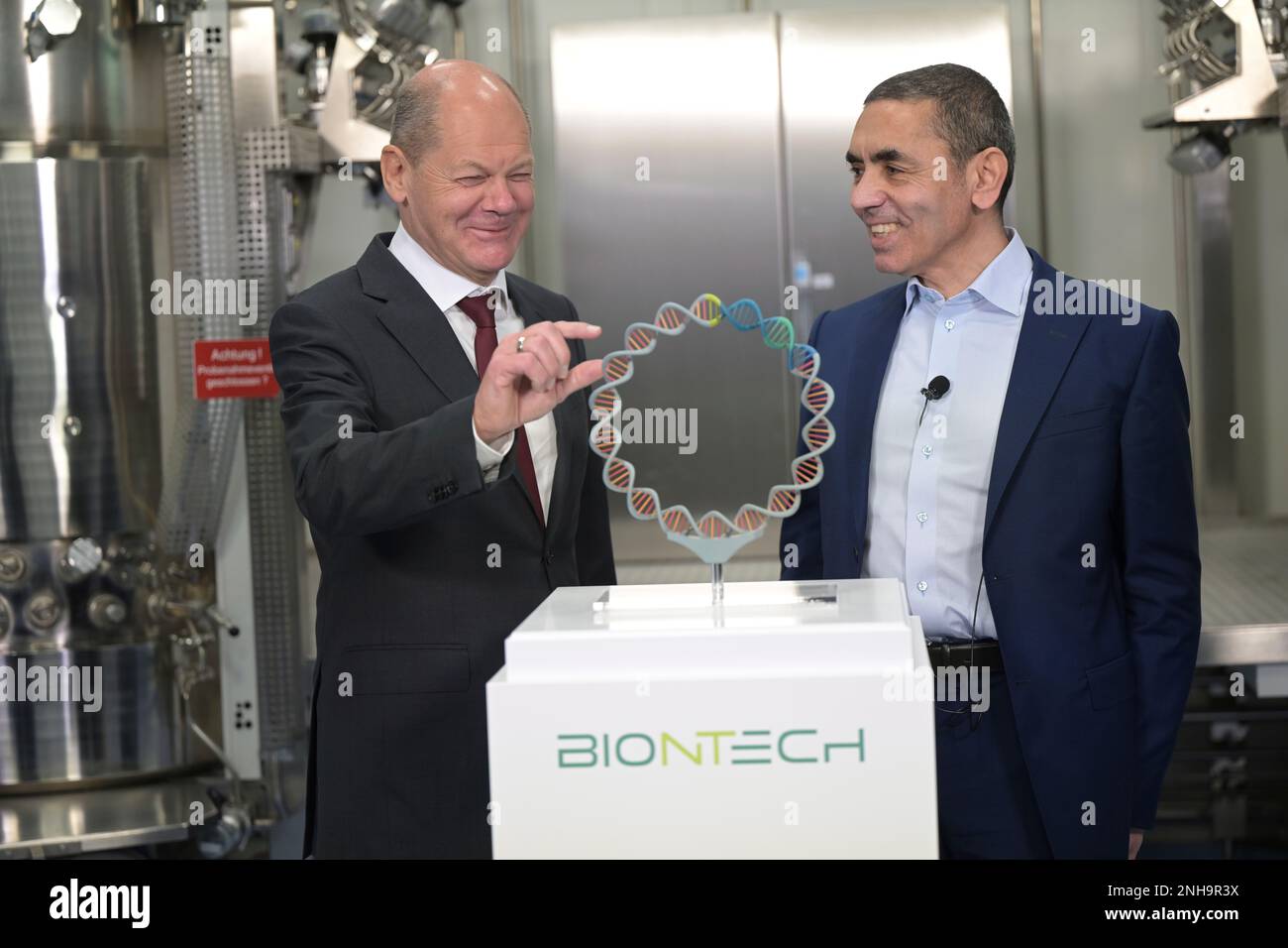 German Chancellor Olaf Scholz, left, is given a tour of the laboratory ...
