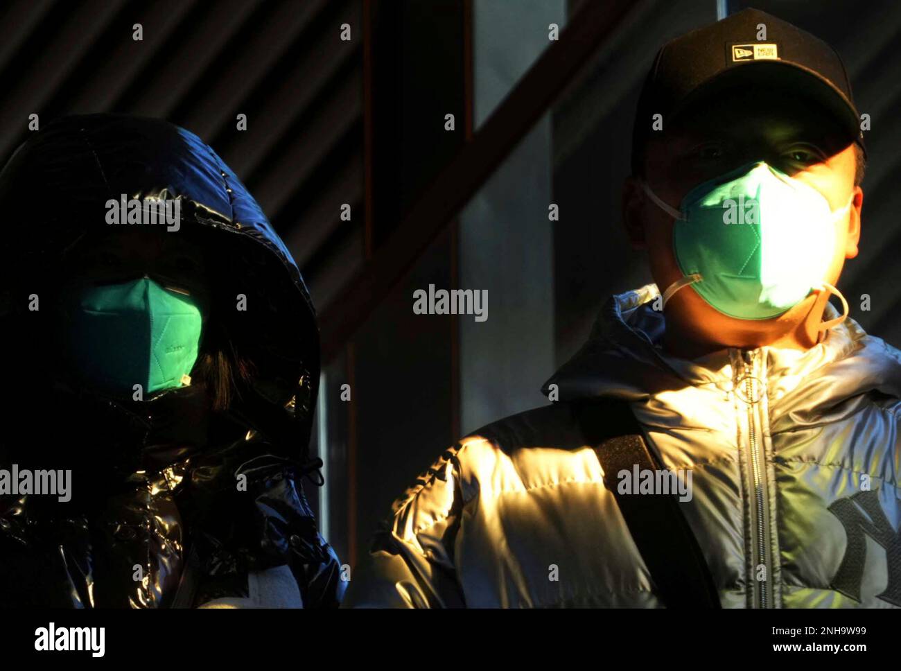 People wearing masks are pictured at a busy area in Beijing, China on ...