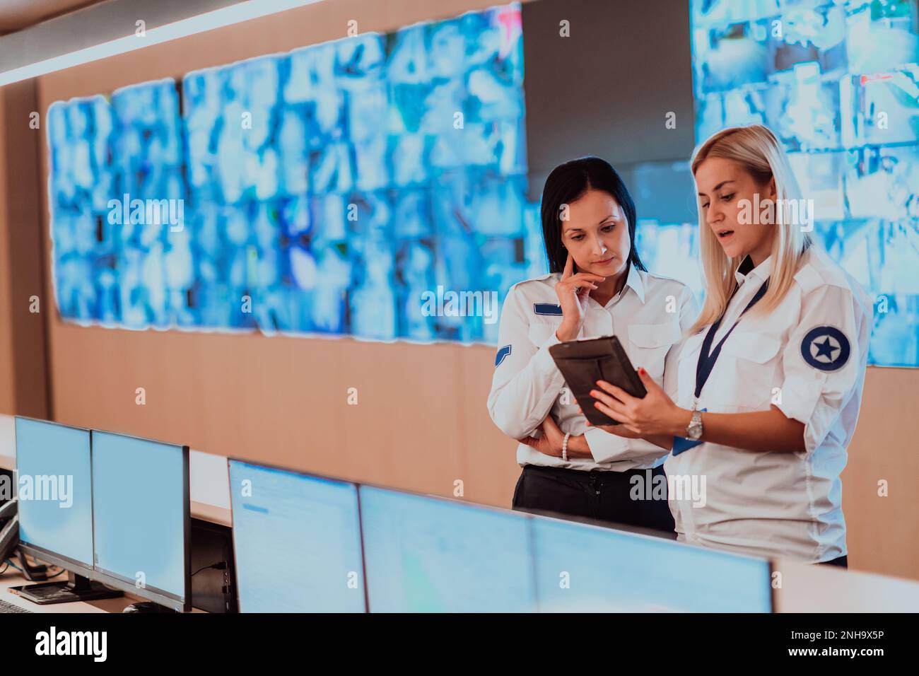 Group portrait of female security operator while working in a data ...