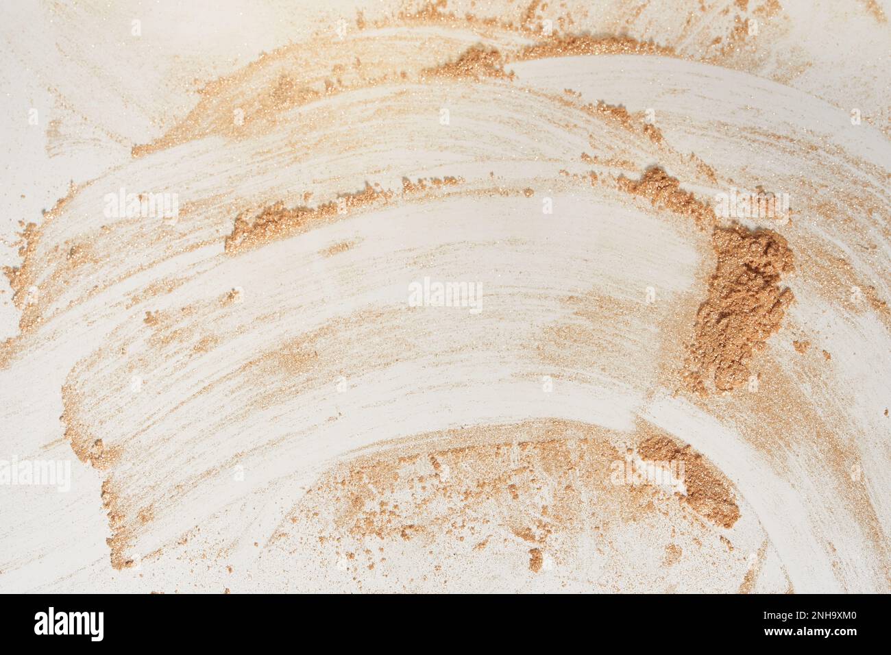 The texture of the powder. A neutral-colored face powder applied to a ...