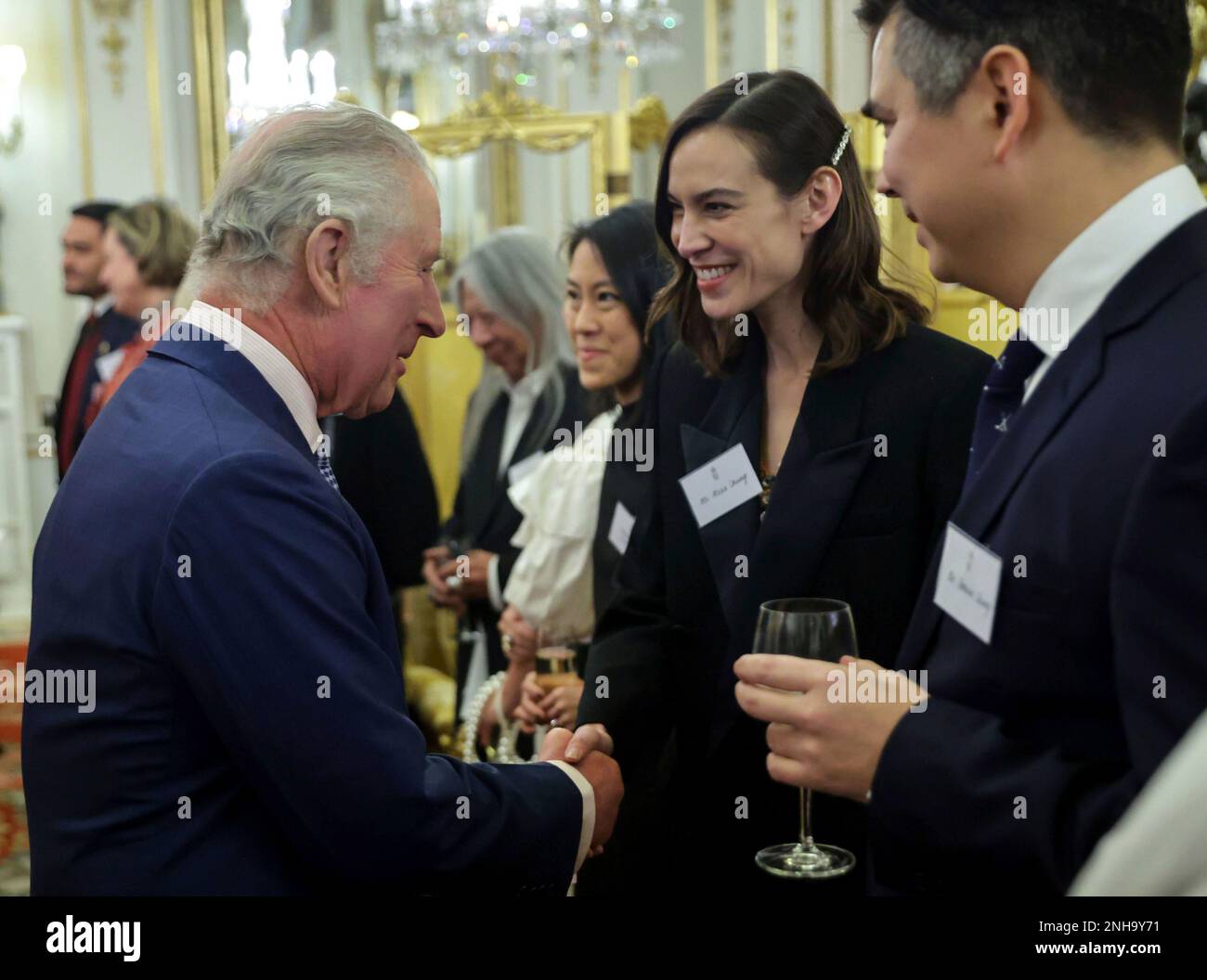 Britain's King Charles III meets Alexa Chung and Dominic Chung during a ...