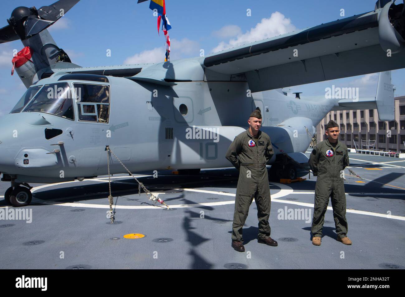 Crew of a V-22 Osprey tilt-rotor aircraft stand by for the media tour ...