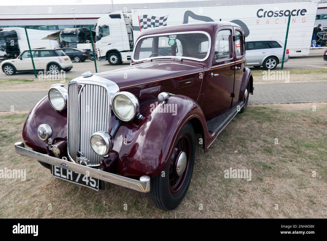 Three-quarters Front View of a 1937, Maroon, Rover 16, parked in front ...