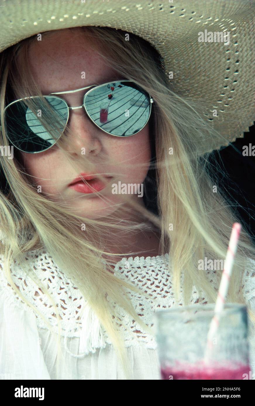Lifestyle. Portrait of teenage girl wearing reflective sunglasses & a ...