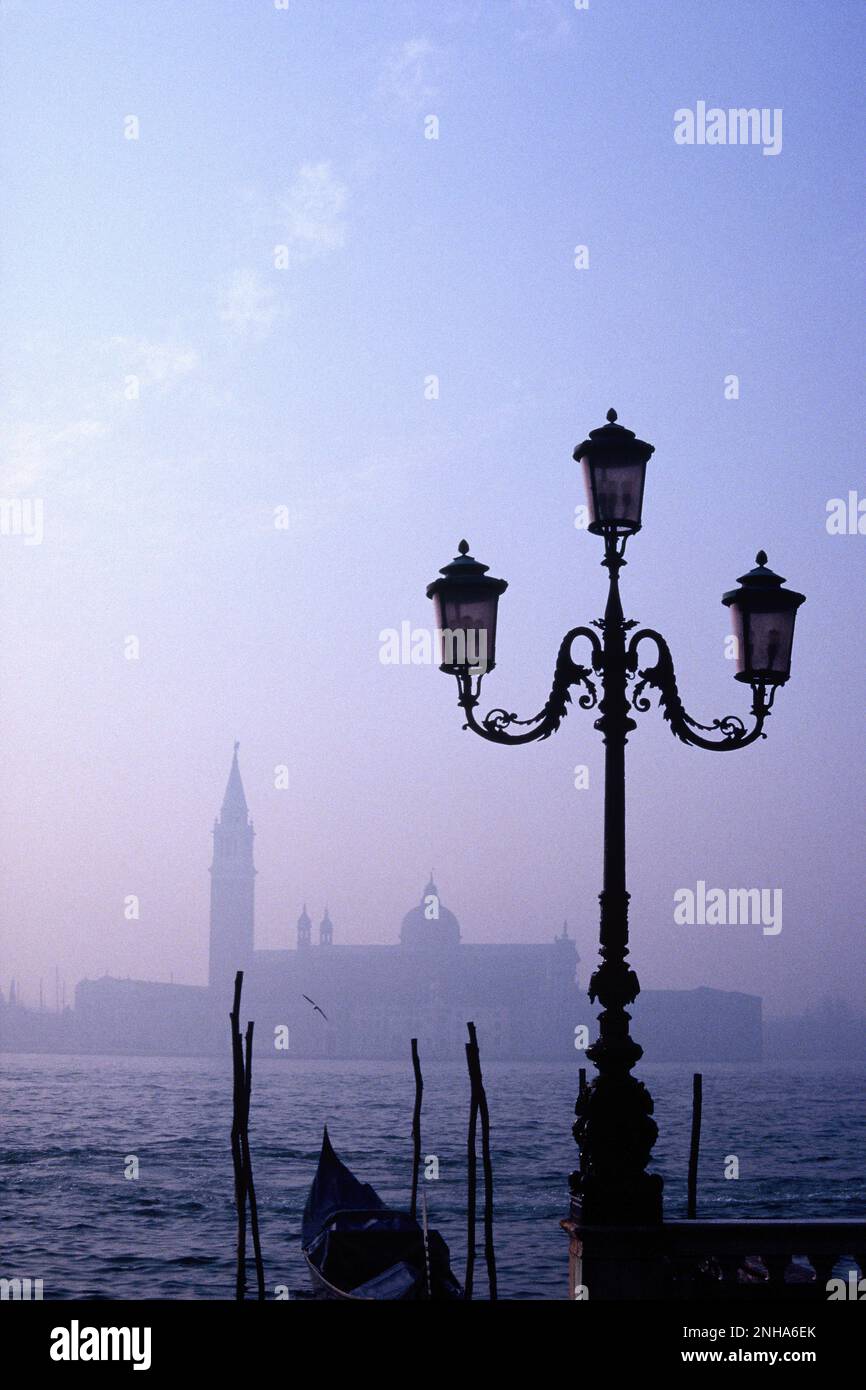 Italy. Venice. Misty waterfront with lamp post & gondola Stock Photo ...