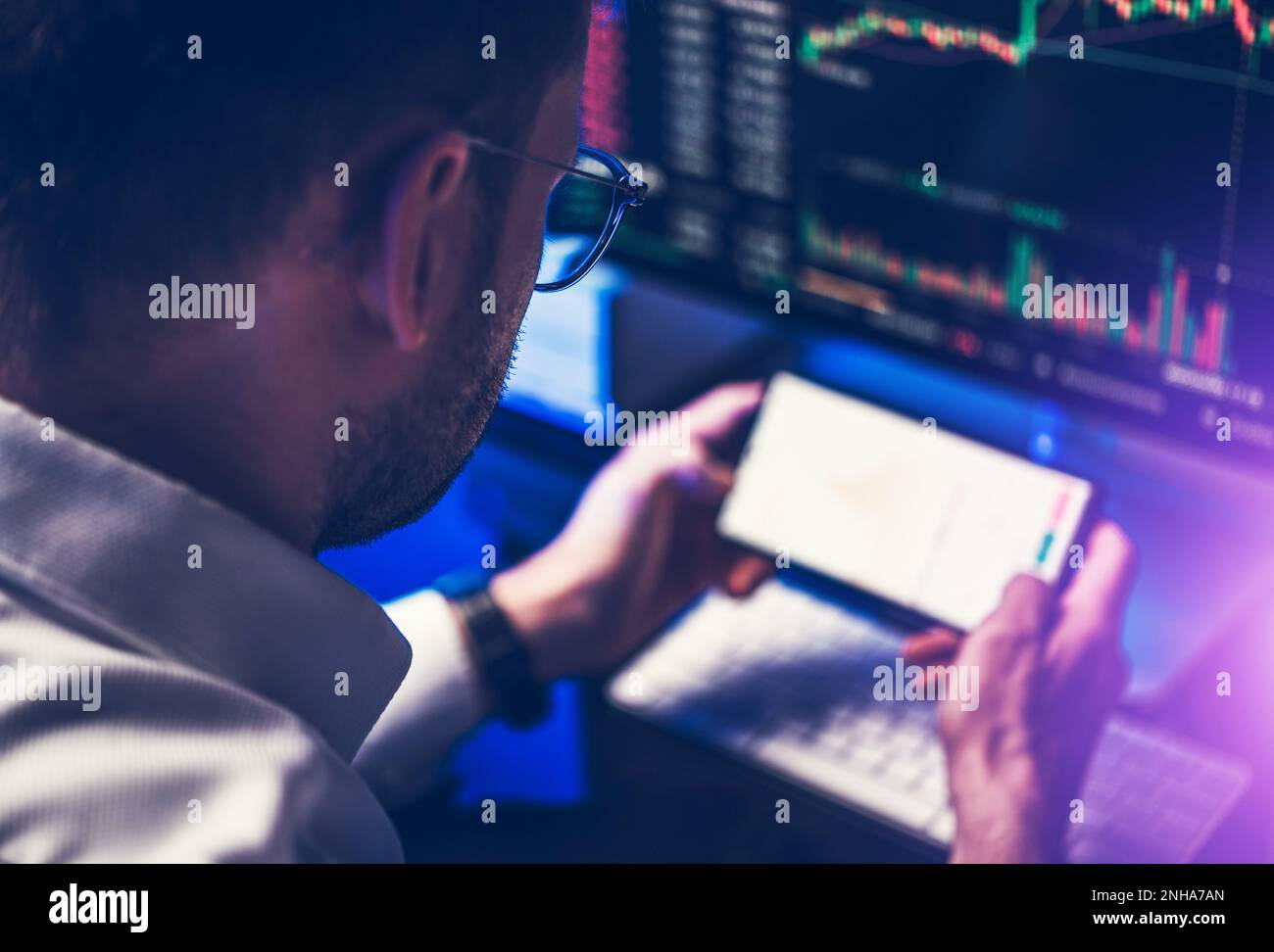 Caucasian Professional Trader in Front of Smartphone and Desktop ...