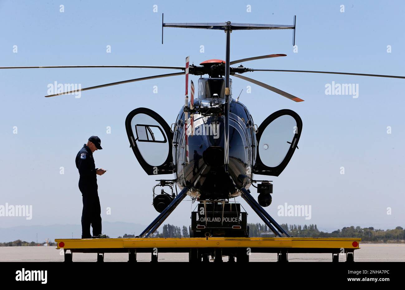 OPD Pilot Sean McClure, safety checks their MD 500e helicopter at their ...