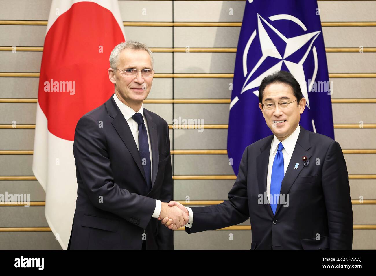 NATO Secretary-General Jens Stoltenberg, left, shakes hands with Japan's Prime Minister Fumio ...