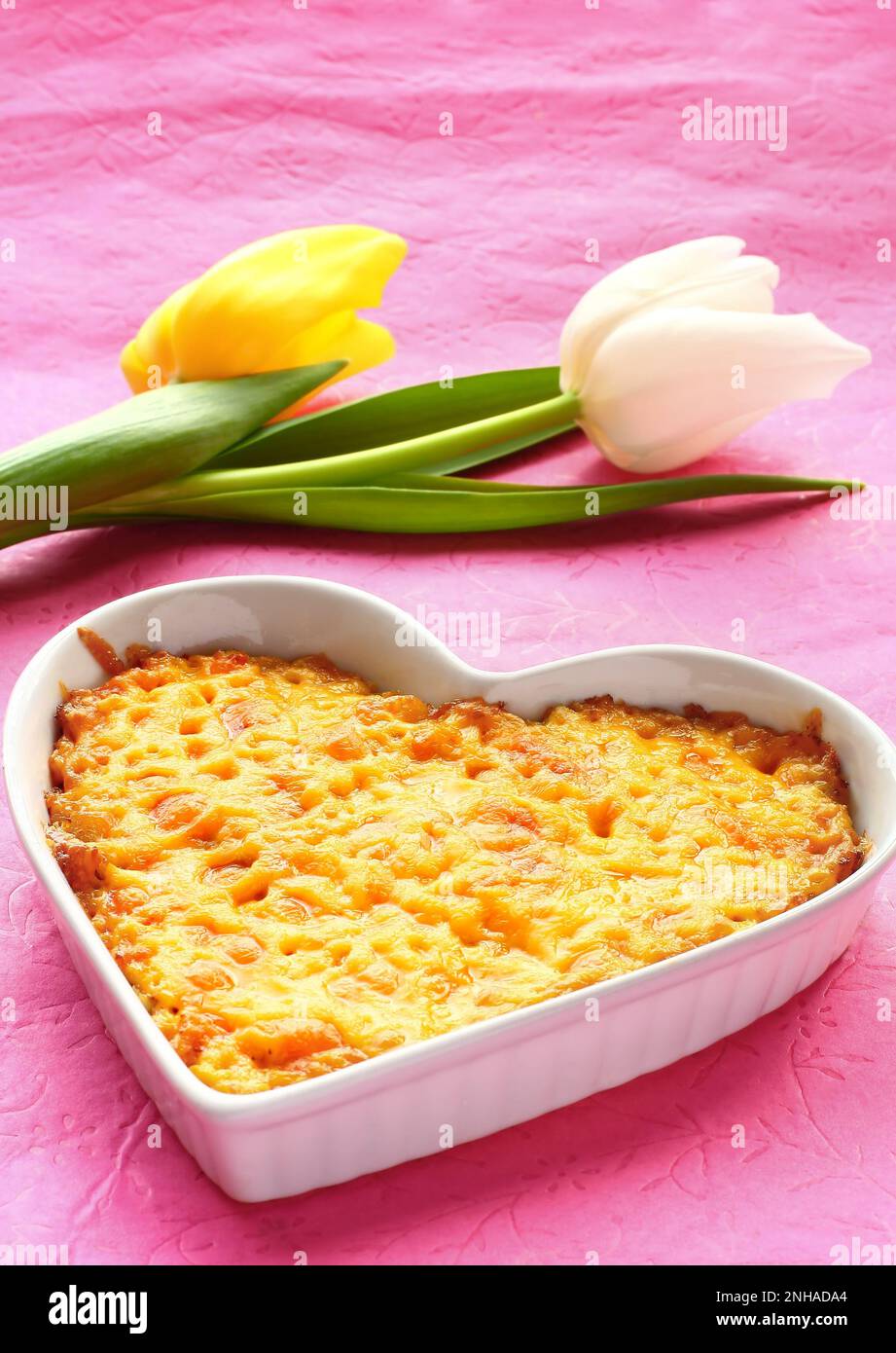 Chicken and cheese gratin in baking dish Stock Photo - Alamy