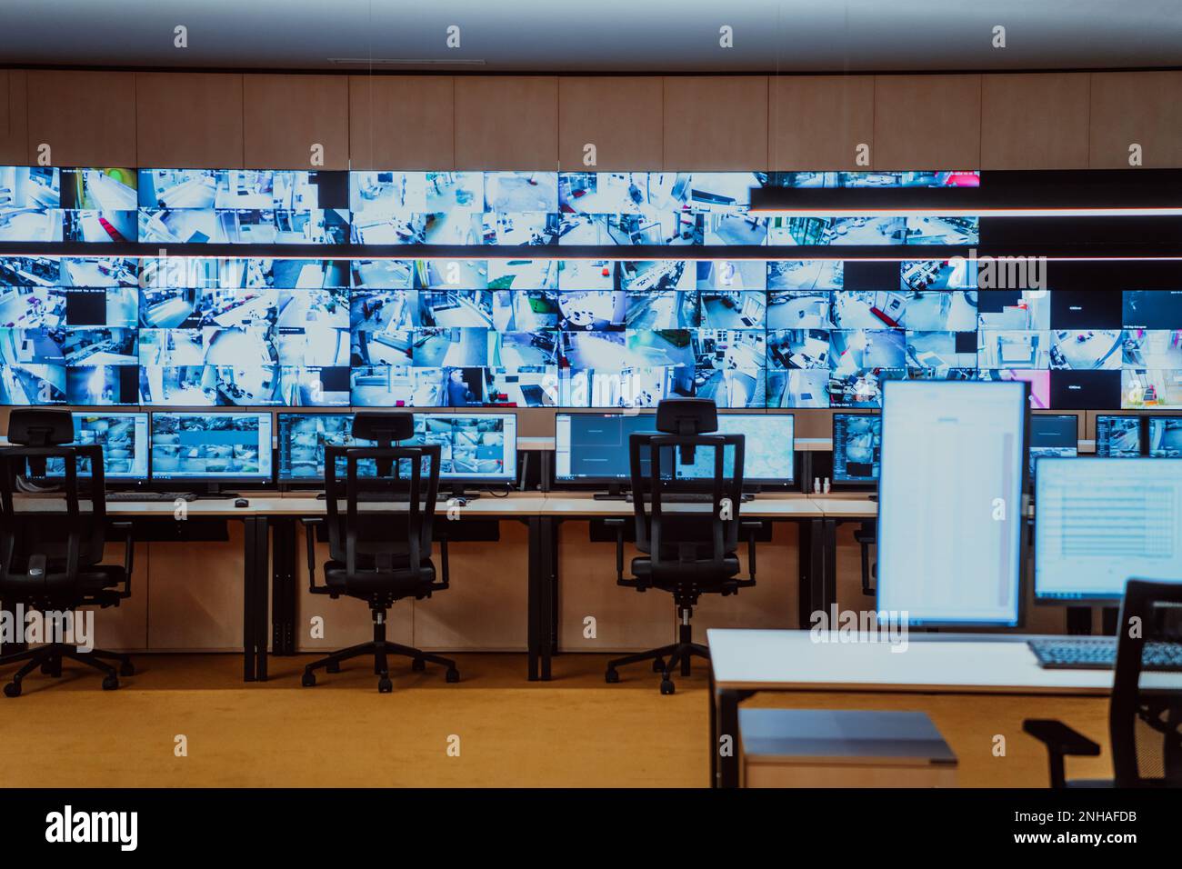 Empty interior of big modern security system control room, workstation with multiple displays ...