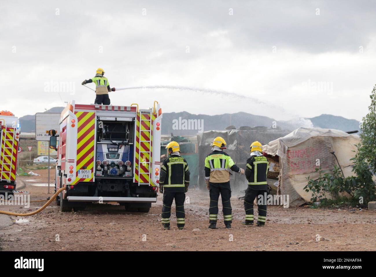 Firefighters extinguish shacks burning in the camp on January 30, 2023 ...