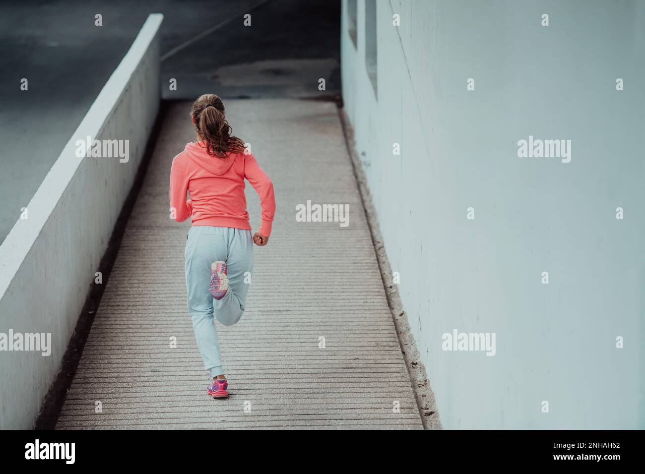 Women in sports clothes running in a modern urban environment. The ...