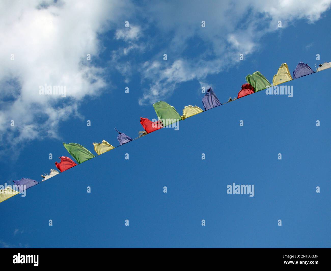 Prayer flags in various colors against the blue sky as a lucky cham ...