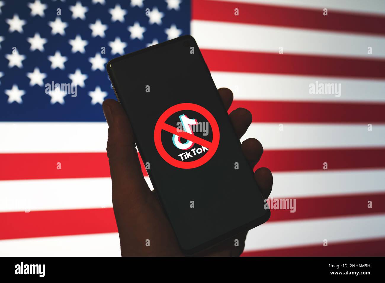 TikTok app logo crossed out with red Ban sign displayed on phone screen ...