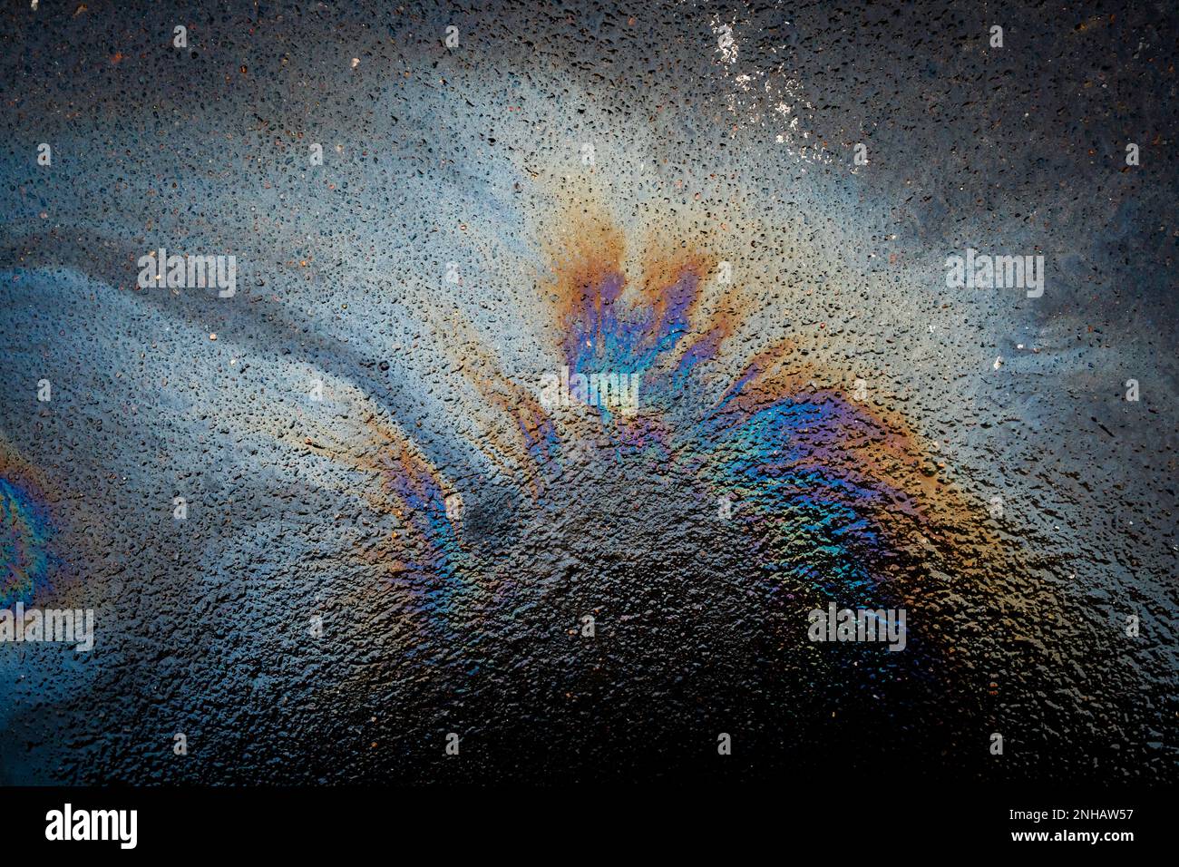 Abstract background from motor oil, gas or petrol spilled on asphalt ...