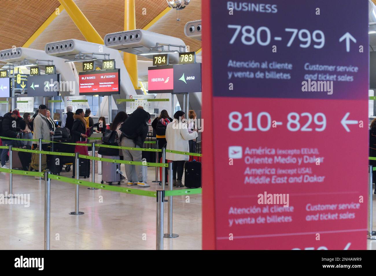Several people wait to board and check in at the departures areaTerminal 4 of Madrid-Barajas ...