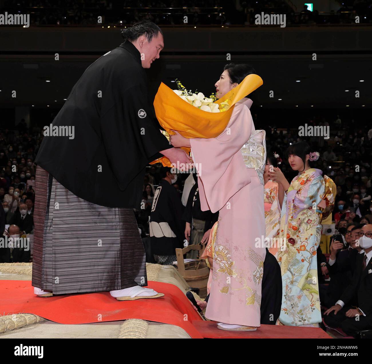 Former yokozuna Hakuo (L) receives a flower from his wife Sayoko during ...