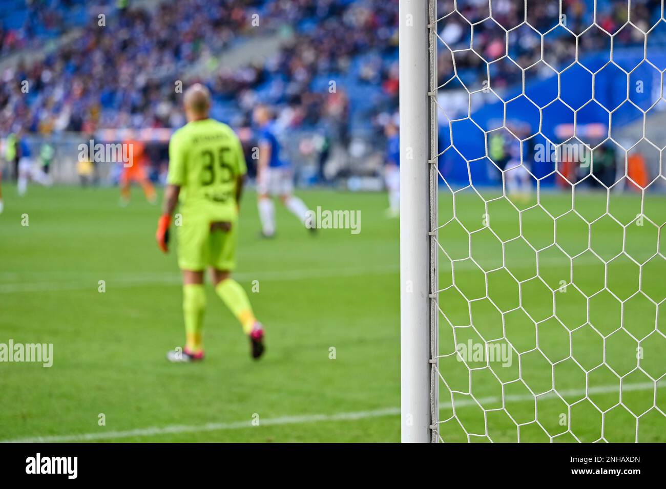 Soccer goal post and soccer match in the background Stock Photo - Alamy