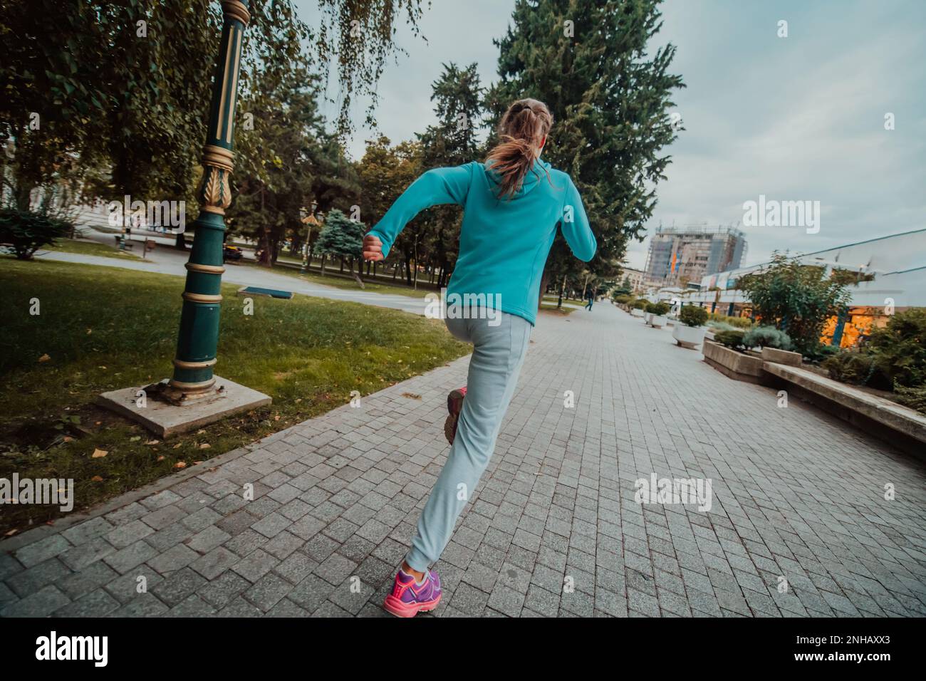 Women in sports clothes running in a modern urban environment. The ...