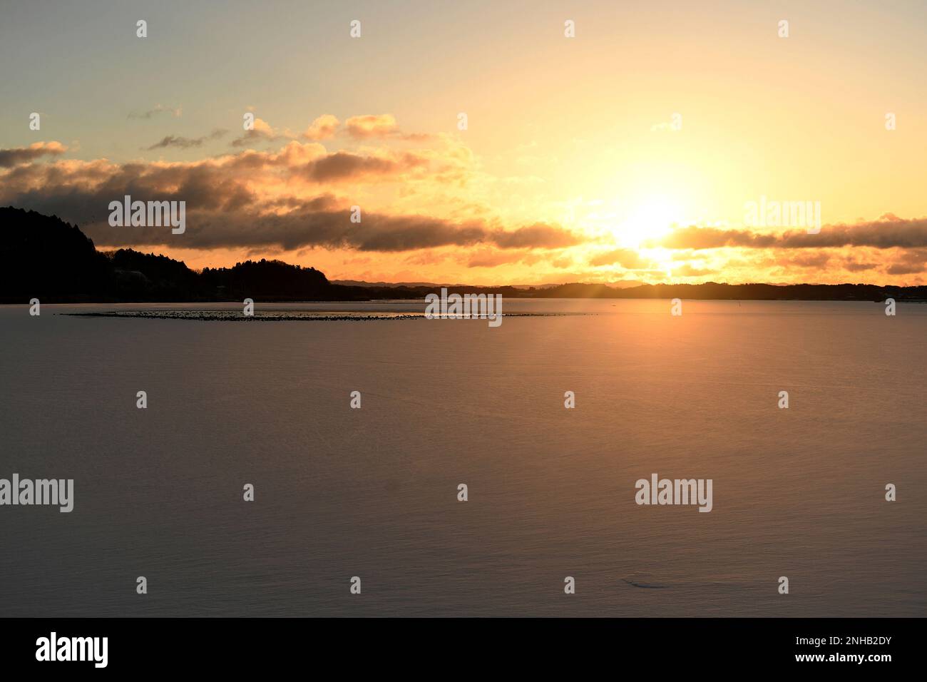 A photo shows mostly frozen Izu numa, Lake Izu, during morning glow in ...