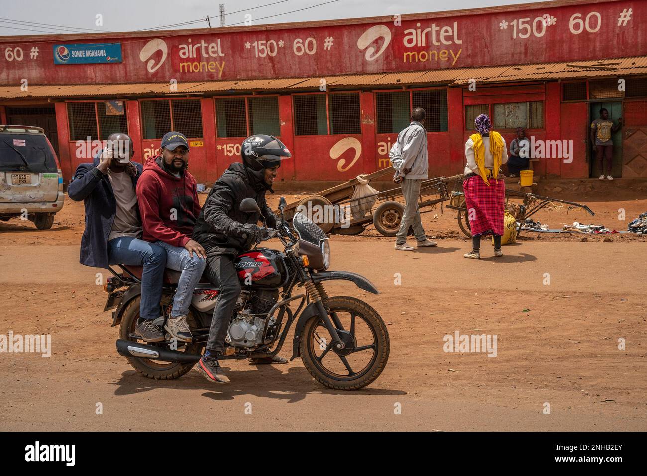 Karatu, Tanzania - October 16th, 2022: A motorcycle cab driver with two ...