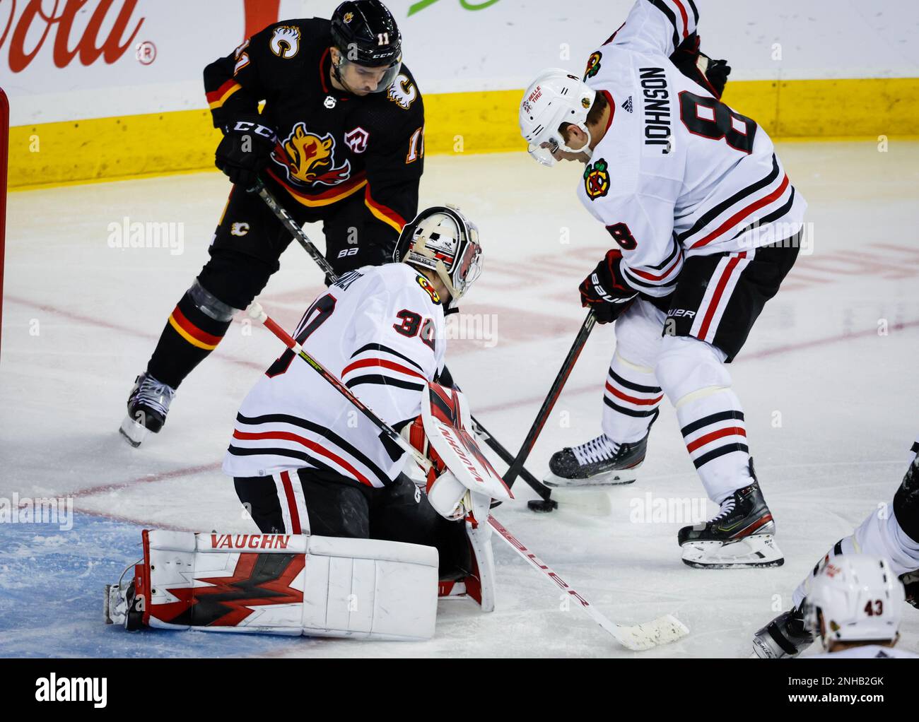 Chicago Blackhawks defenseman Jack Johnson, right, battles for the puck ...