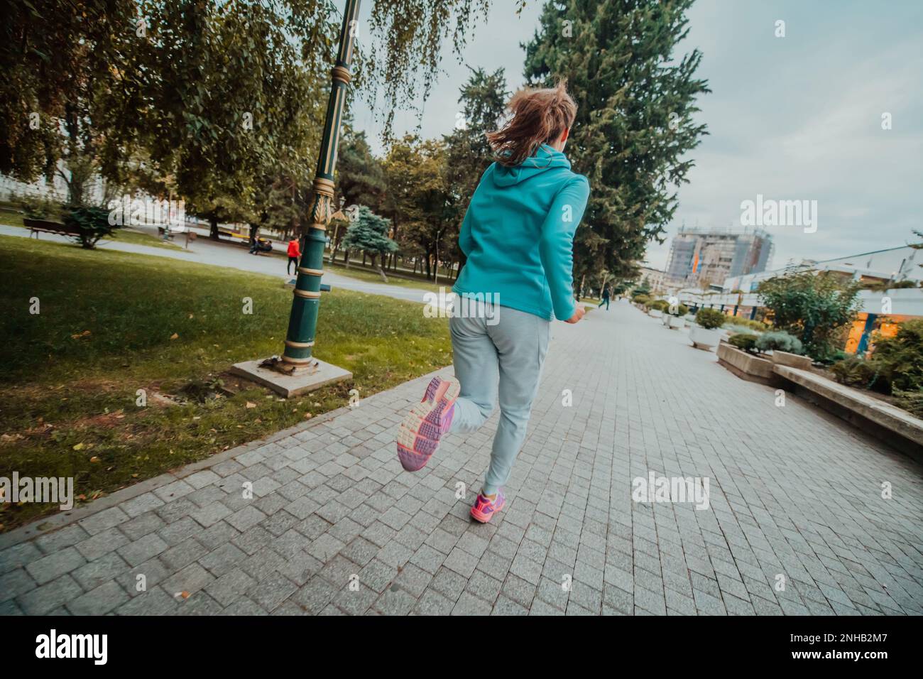 Women in sports clothes running in a modern urban environment. The ...