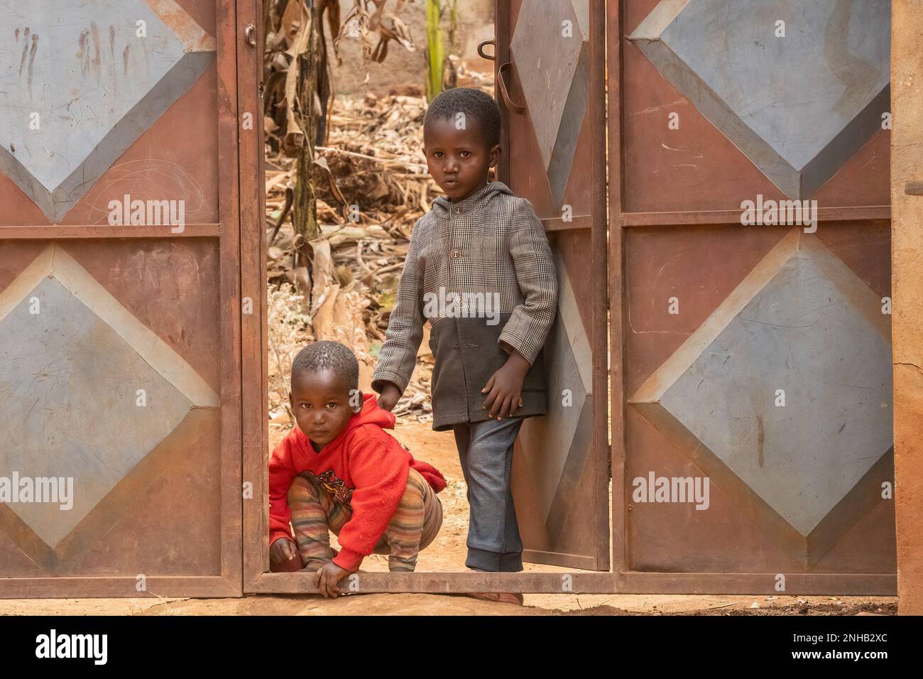 Karatu, Tanzania - October 16th, 2022: Two children at their yard gate ...