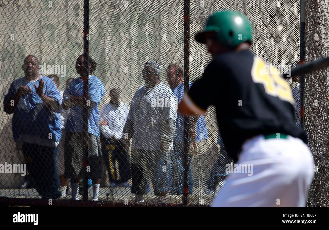 Inmates watch the game as Chris Marshall, (45) gets set to bat for the ...