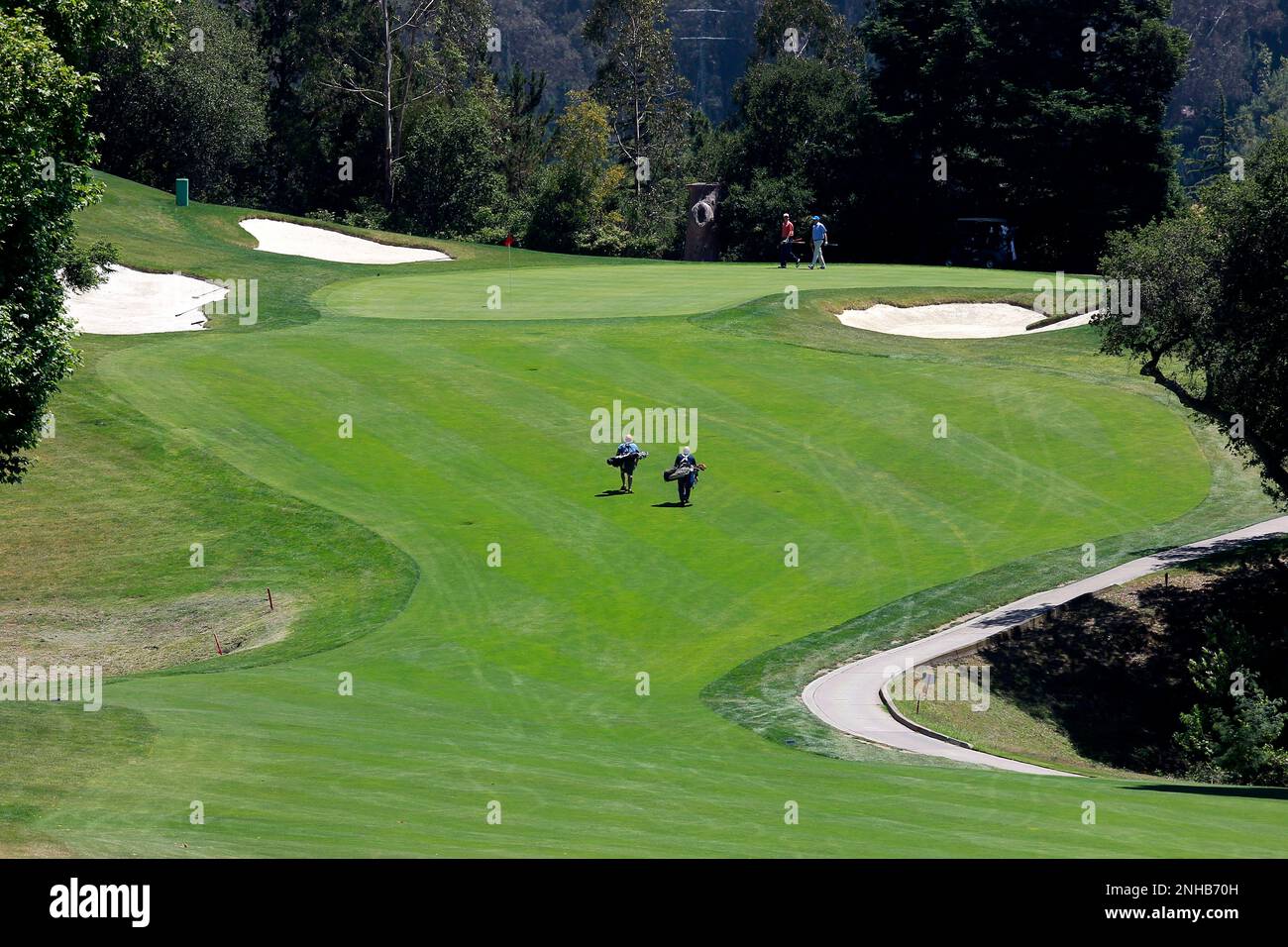 Members climb the fairway to the fourth hole green at the Sequoyah ...
