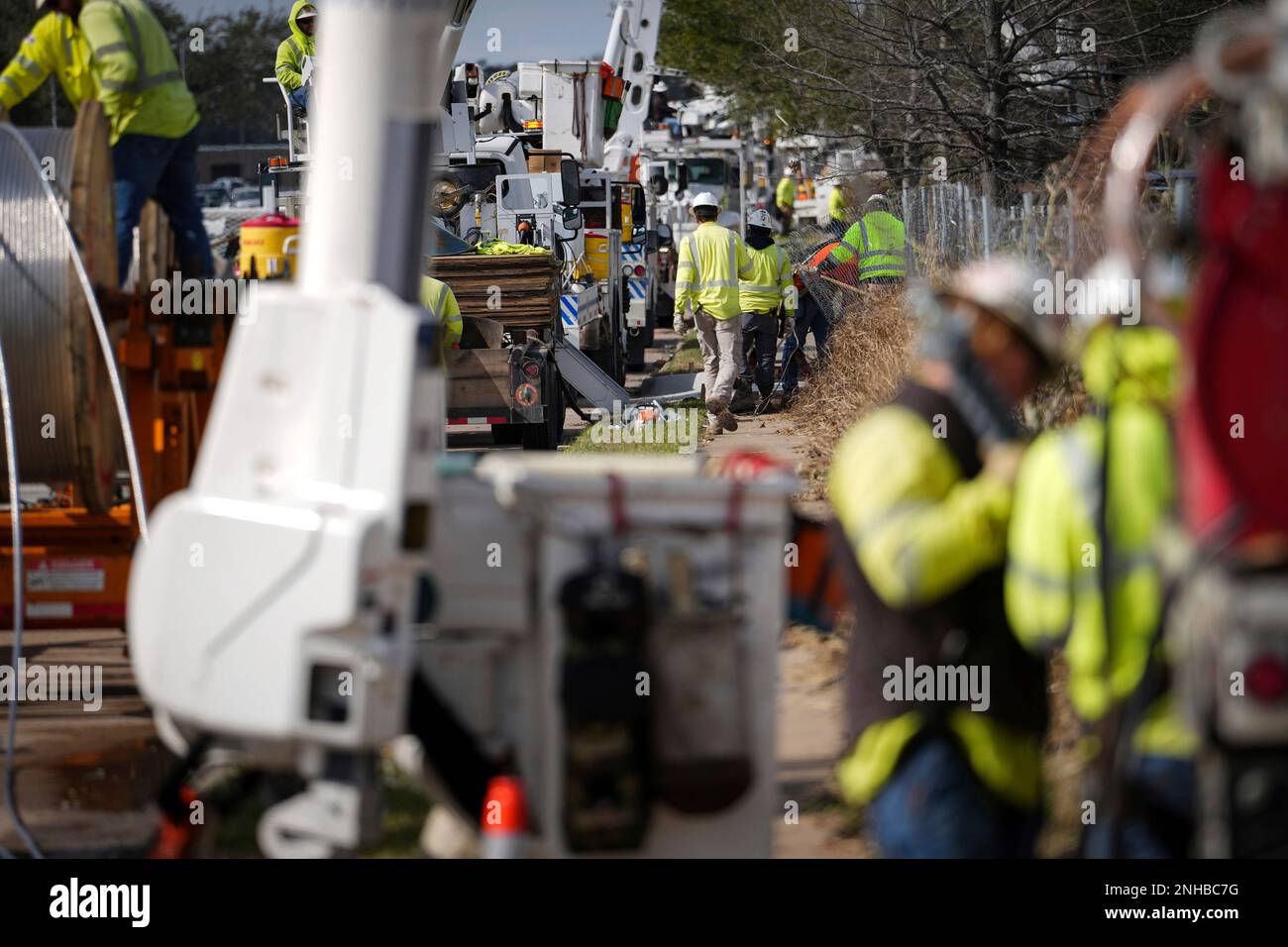 Line workers with North Houston Pole Line work to restore power ...