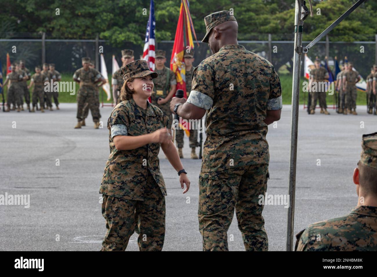 U.S. Marine Corps 1st Sgt. Jessica Davila hands the microphone to Sgt ...