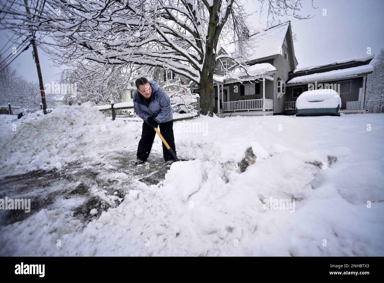Nicole Heavner, of Brattleboro, shovels part of the driveway on Monday ...