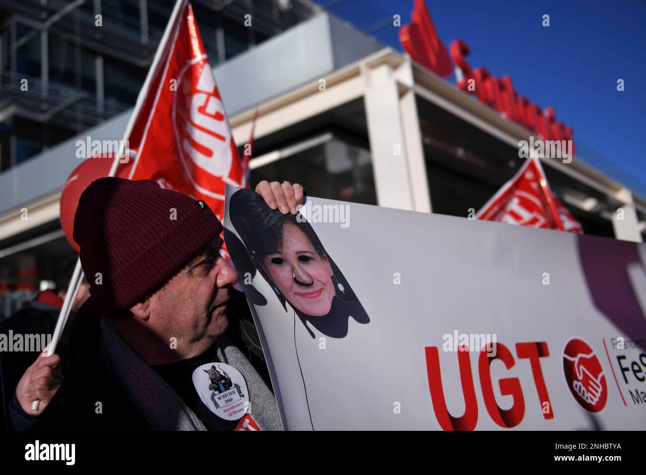 A man wearing a mask of the president of Banco Santander, Ana Patricia ...