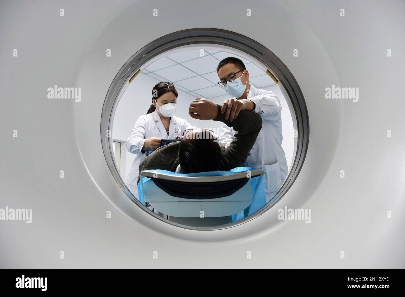 Doctors help a patient for a CT scan at a hospital in Handan city in ...