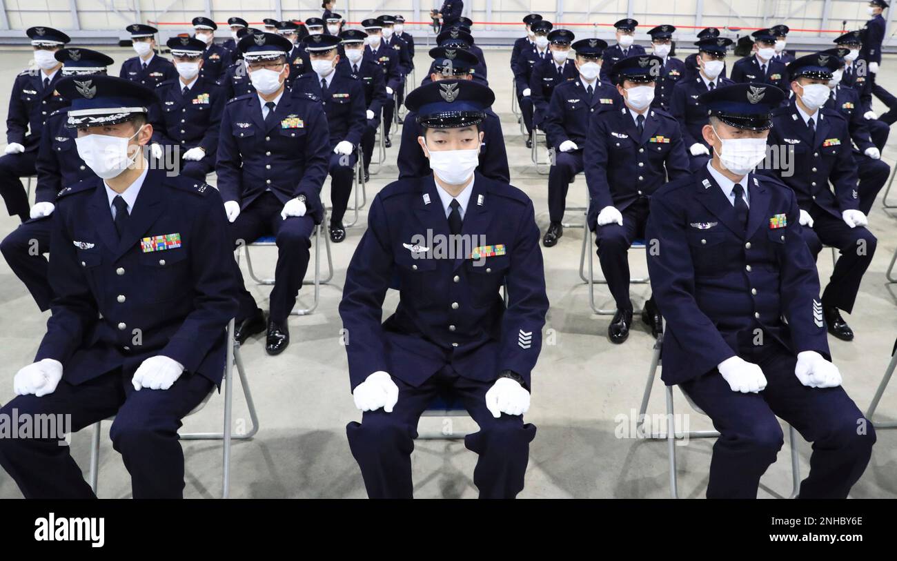 Members of of the Japan Air Self-Defense Force (JASDF) sit in line ...