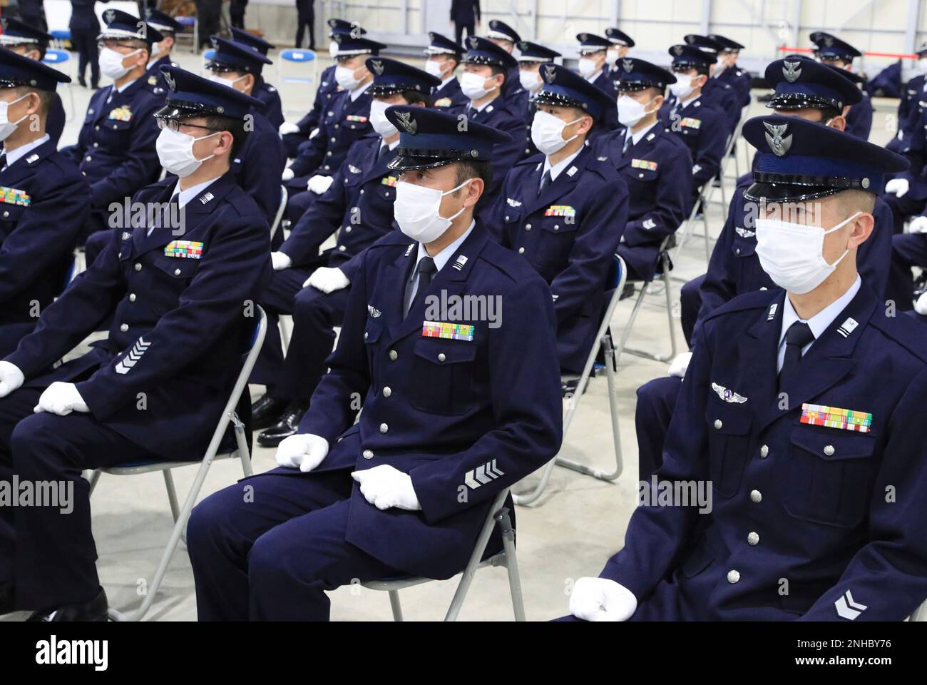 Members of of the Japan Air Self-Defense Force (JASDF) sit in line ...